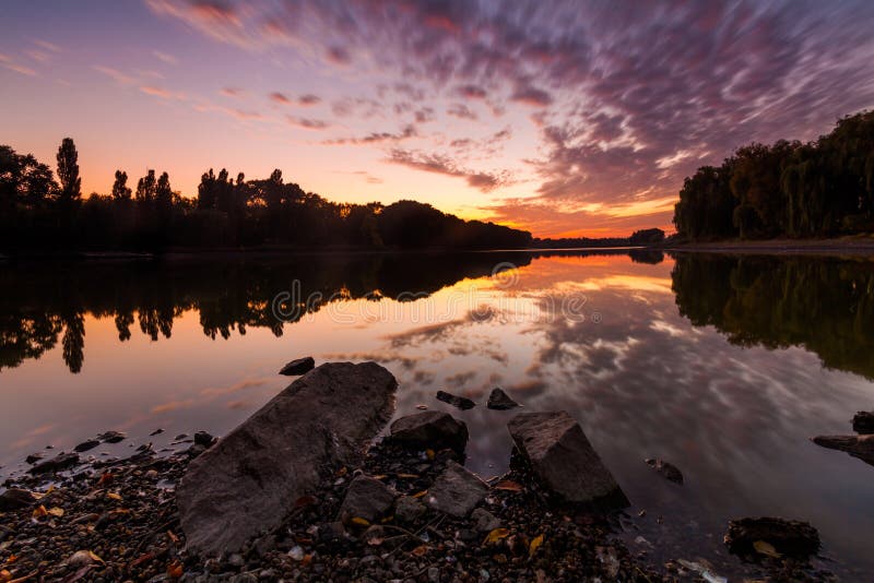 Saturated Red Sunrise Over Lake Stock Photo - Image of overcast, beauty ...