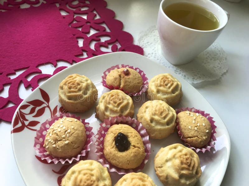 On the Saucer There are Cupcakes, in Paper Form for Baking. There is a ...