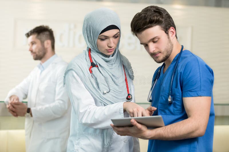 Saudi Arab Doctors Working with a Tablet. Stock Photo - Image of ...