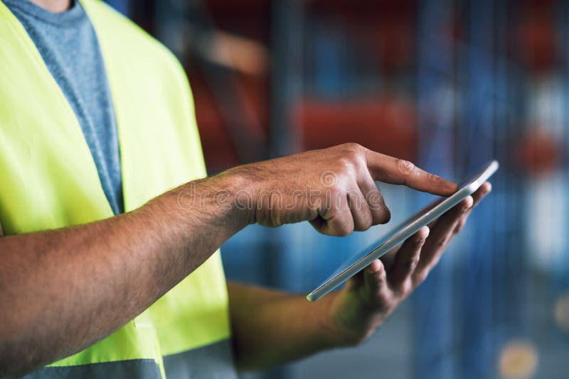 Save Time, Conduct Inspections Online. a Builder Using a Digital Tablet ...