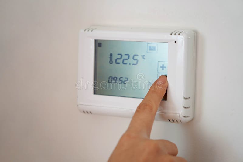 Saving Energy Concept: Human Hand Turning Down Temperature on Digital ...