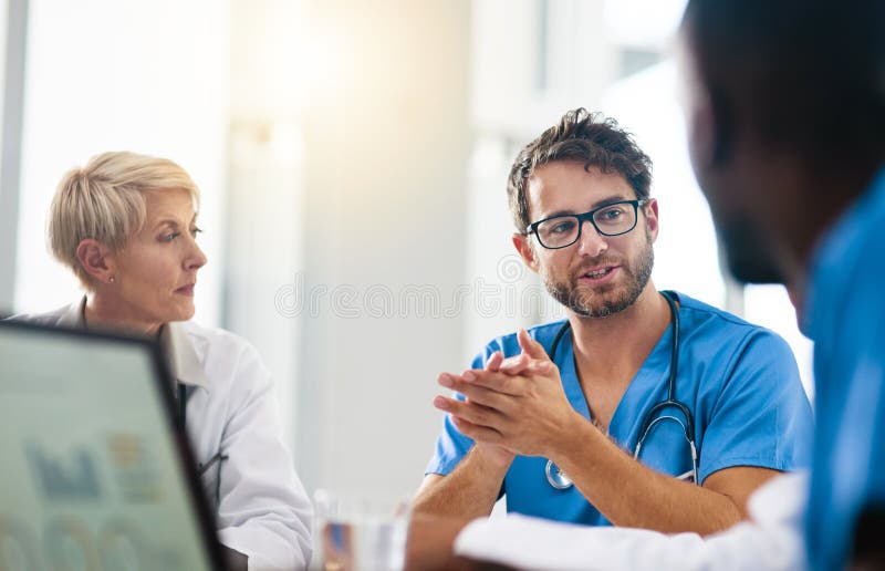 Saving Lives with a Solid Strategy. a Team of Doctors Having a Meeting ...