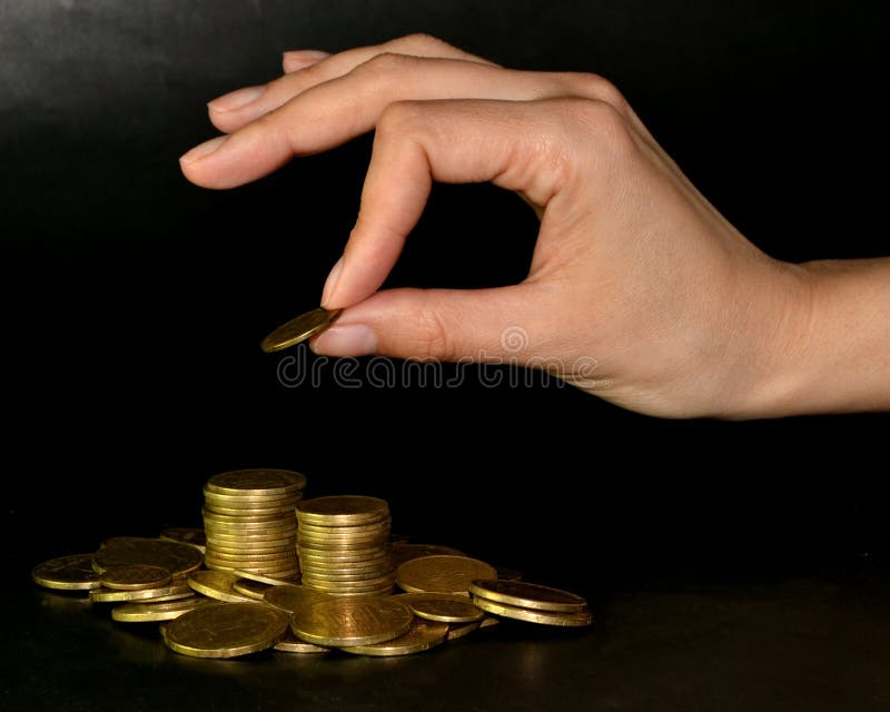 Saving Money Concept by Adding Gold Coin To a Pile of Coins Stock Image ...