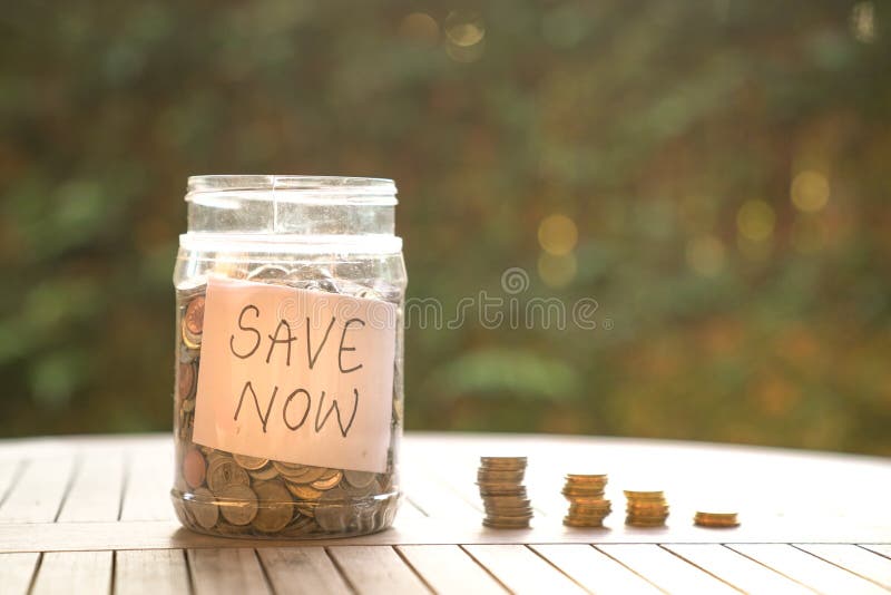 Saving Money Concept : Coins in Container and Stacked on Table Stock ...