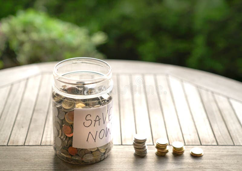 Saving Money Concept : Coins in Container and Stacked on Table Stock ... Saving Money Concept : Coins in Container and Stacked on Table Stock ...