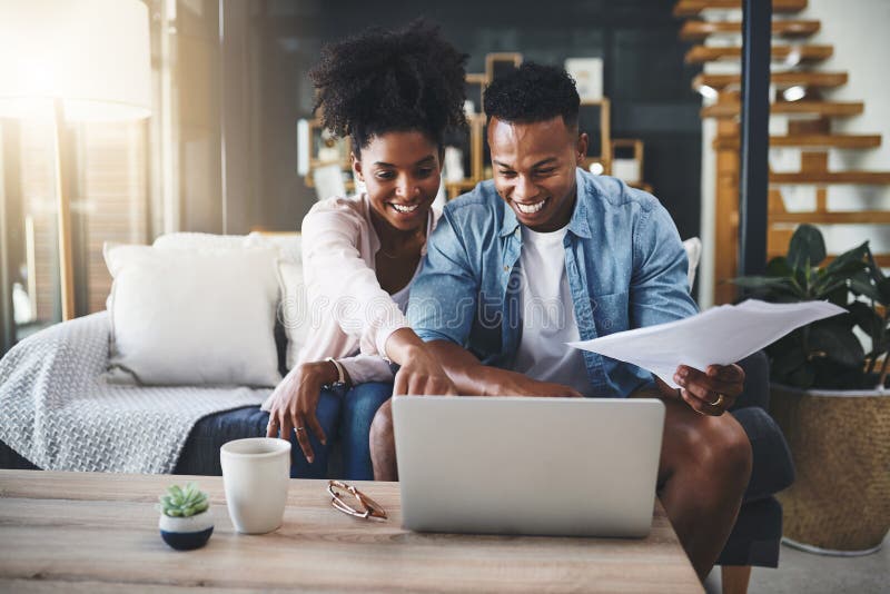 Saving Pays Off. a Young Couple Going through Their Paperwork Together ...