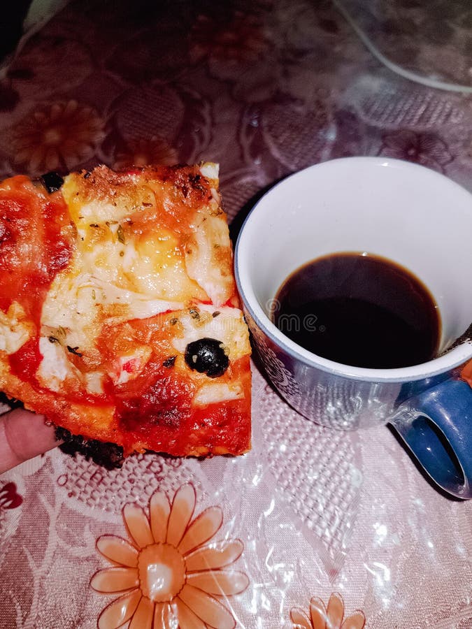 Savoring a Slice of Pizza with a Steaming Cup of Coffee Stock Photo ...