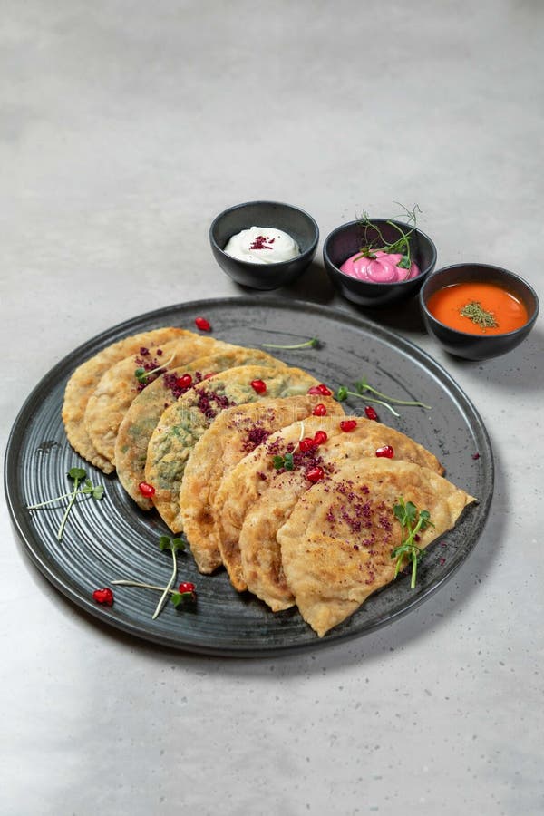 Savory Flatbreads are Served on a Plate with Dipping Sauces Stock Photo ...