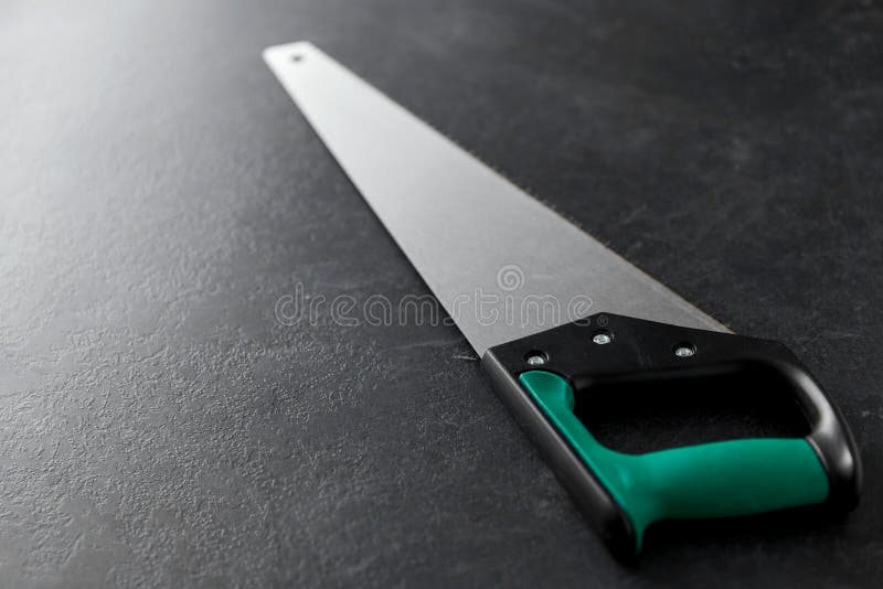 Saw on slate background stock image. Image of armsaw - 184429869