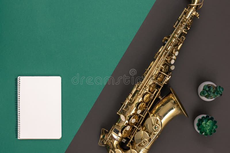 Saxophone on a Green Background and Notepad, Top View. Stock Photo ...