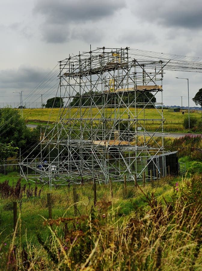 Scaffold tower in a field stock photo. Image of transmission - 98814100
