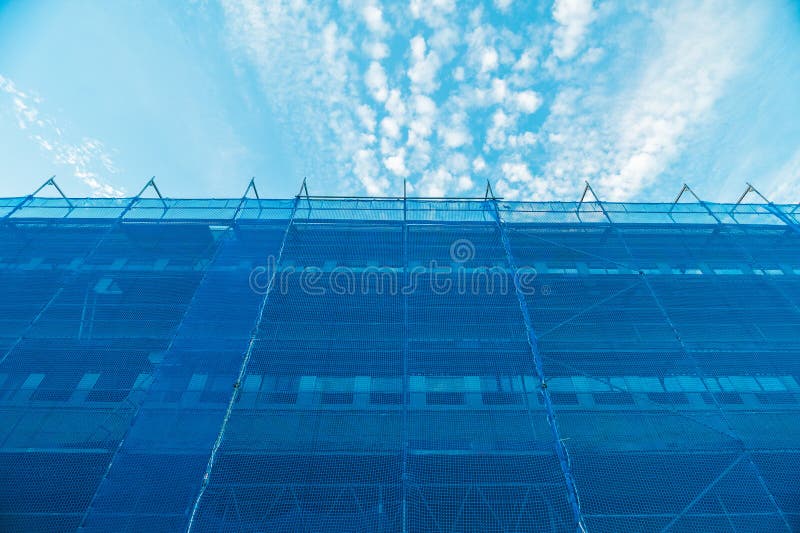 Scaffolding Construction Frame with Blue Safety Net on a Building Stock ...