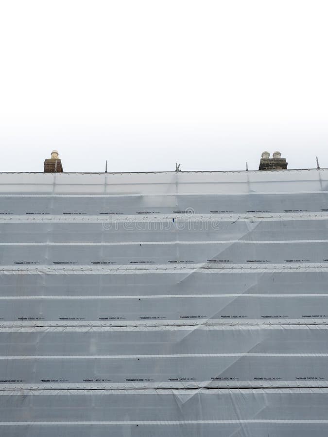 Scaffolding Covered with White Safety Net in a City. House ...