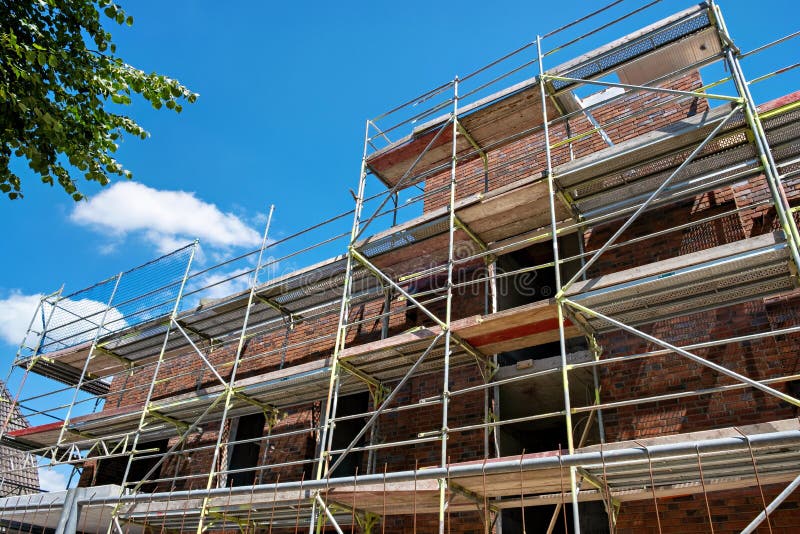 Scaffolding Near a High-rise Brick House Under Construction in Germany ...