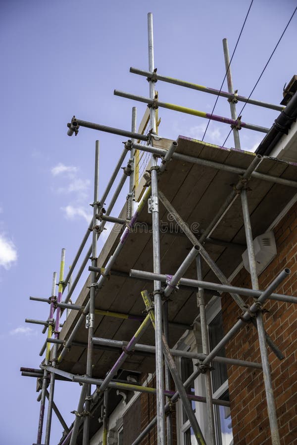 Scaffolding Poles Erected on the Side of a British House Stock Photo ...