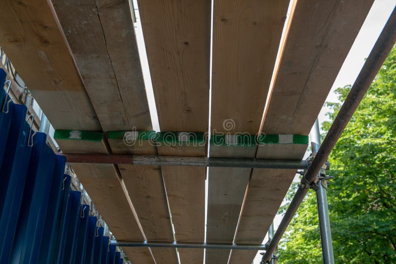 A Scaffolding and Wooden Planks for Protection and Coverage on a ...