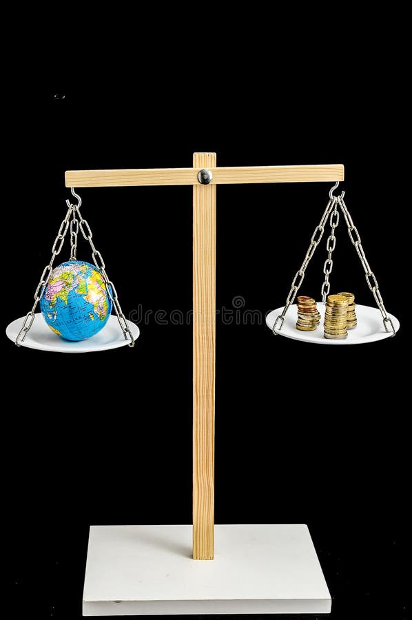 A Scale with a Globe on One Side and Coins on the Other Stock Photo ...