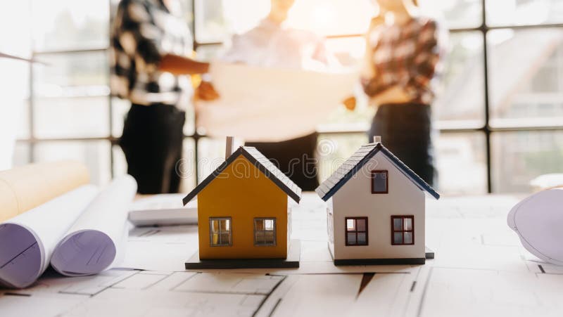 Scale Model House on Table with Architects. Two Architects Making ...