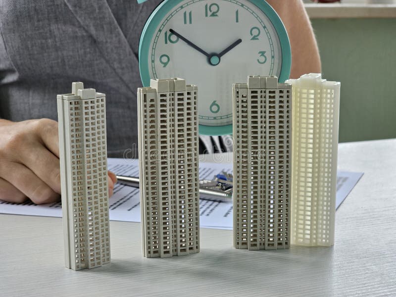Scale Models of Buildings Displayed on Table with a Clock, Highlighting ...