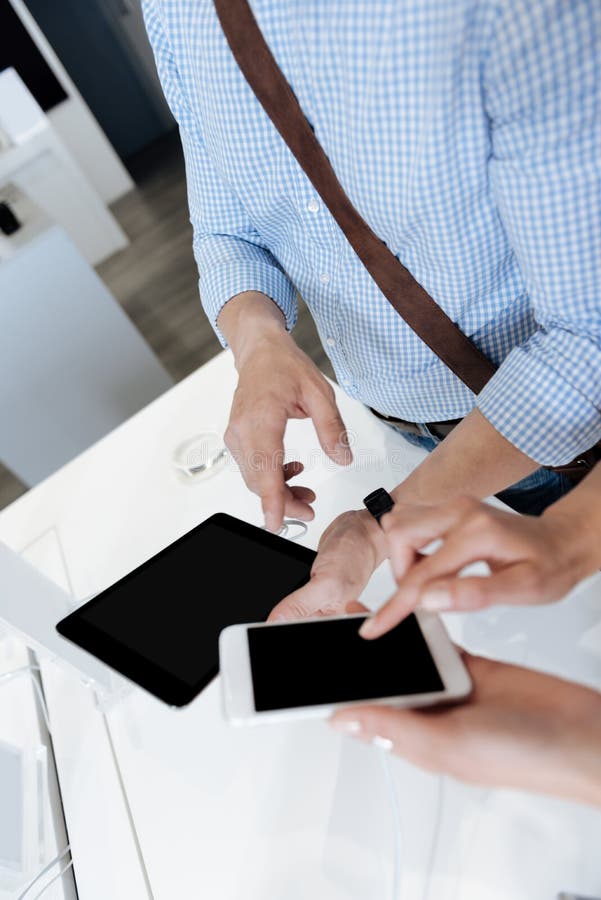 Scaled Up Shot of Shoppers Trying Out Different Technological Devices ...