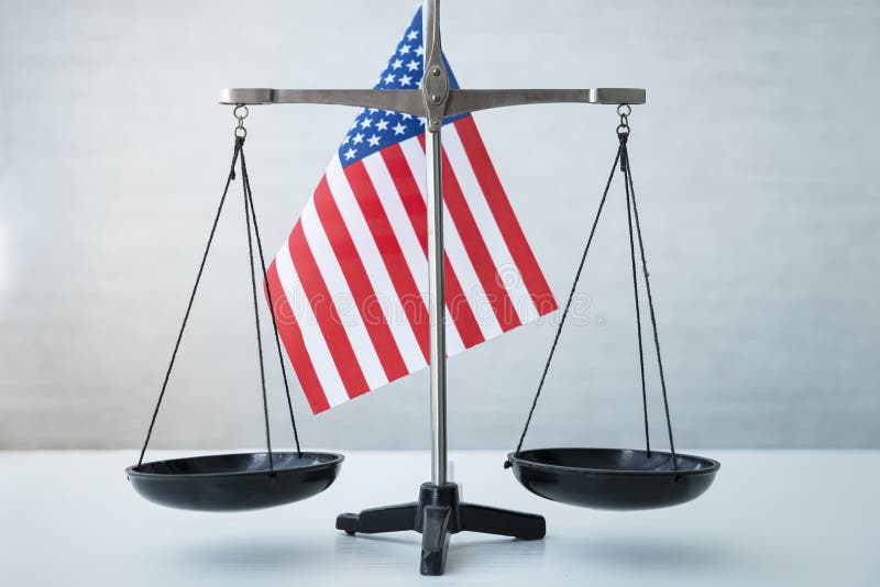 Scales of Justice with American Flag on Wooden Table Stock Photo ...
