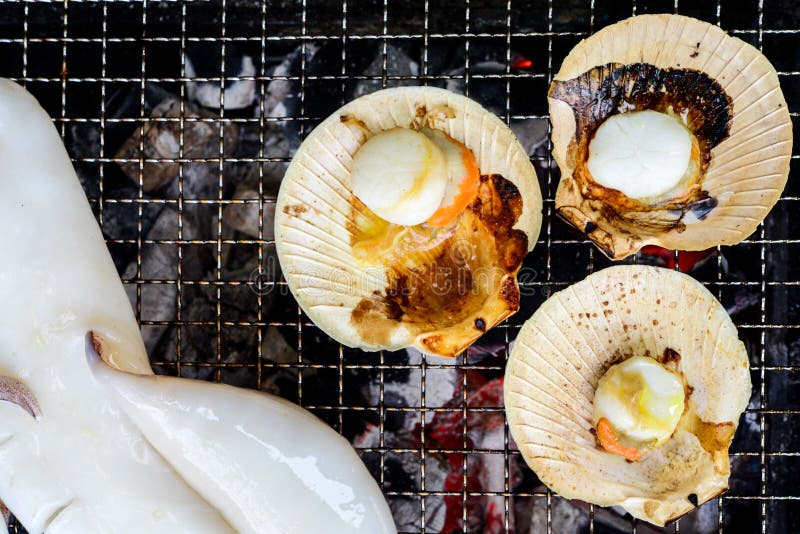 Scallop Seashell on the Grill with Flames Closeup Stock Photo - Image ...