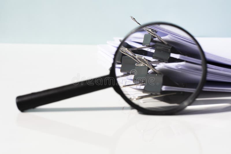 Scanning Business Documents. Magnifying Glass on the Stack of Documents ...