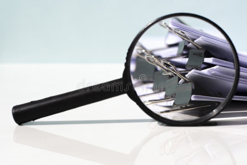 Scanning Business Documents. Magnifying Glass on the Stack of Documents ...