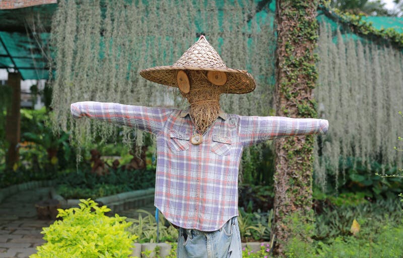 Scarecrow In Farm Garden And Log Cabin Stock Photo - Image of crow ...