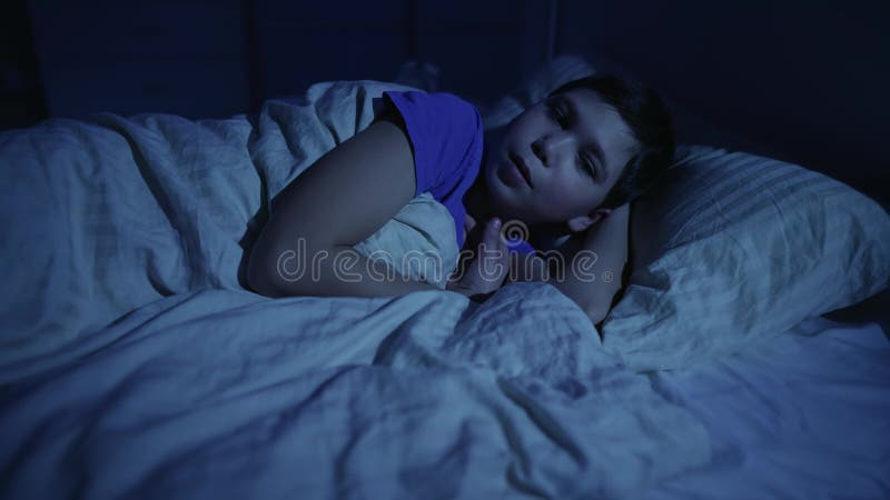 Scared boy in bed at night stock video. Video of darkness - 277837433