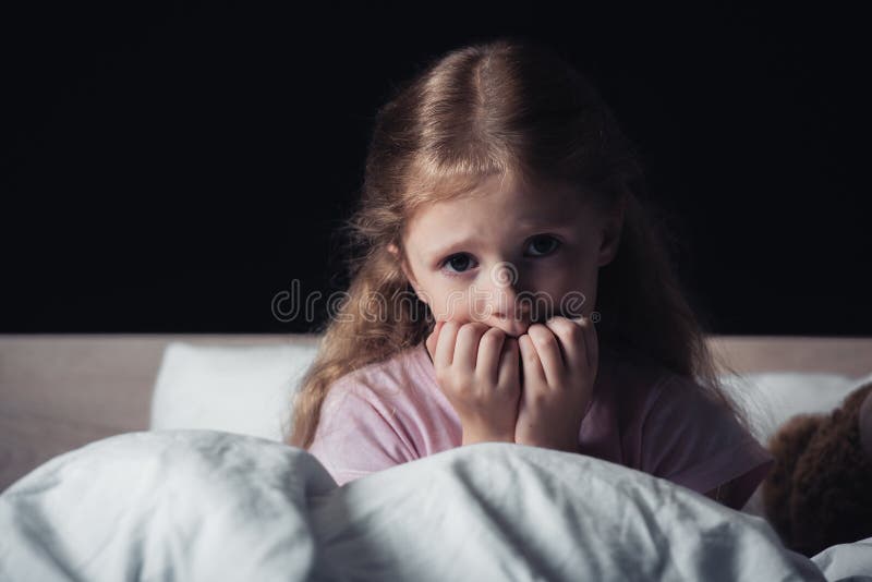Scared Child Looking at Camera while Sitting on Bedding Stock Image ...
