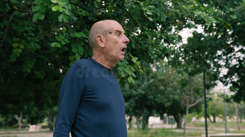 Scared Elderly Bald Man Looks Terrified in Shock Sitting Under a Tree ...