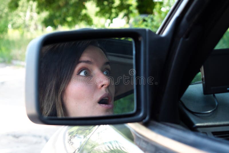 Scared Face of a Girl in a Side Mirror of a Car. Scared Driving a Car ...