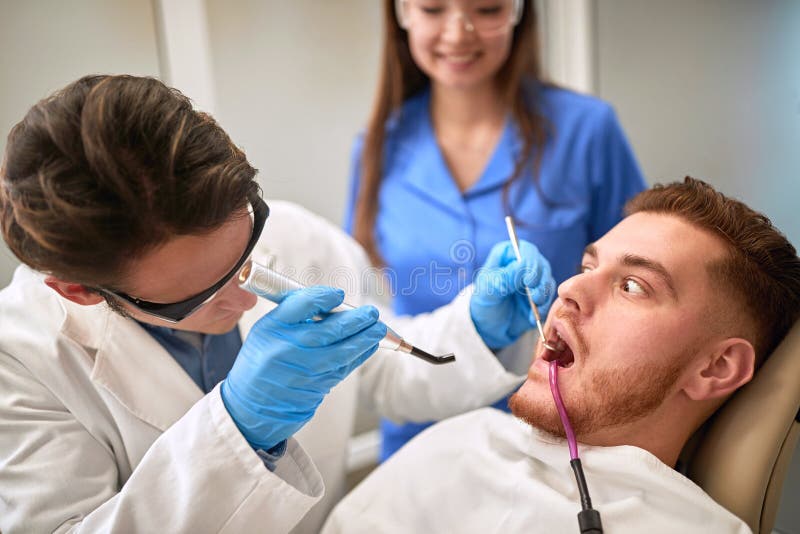 Scared Patient at Dentist Repairing Tooth Stock Photo - Image of health ...