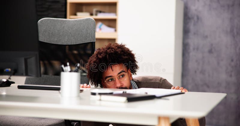 Scared Man Hiding Behind Office Desk Stock Photo - Image of looking ...