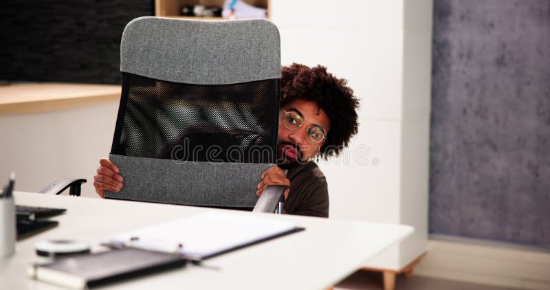 Scared Man Hiding Behind Office Desk Stock Photo - Image of unhappy ...