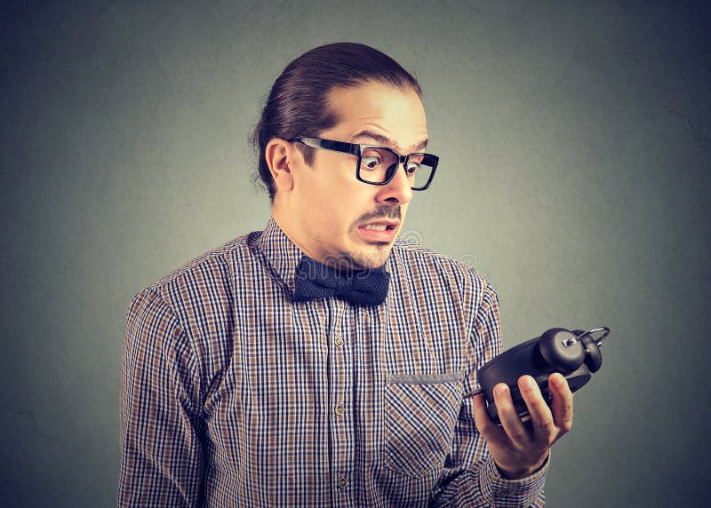 Scared Man Looking at Alarm Clock Stock Image - Image of glasses, miss ...