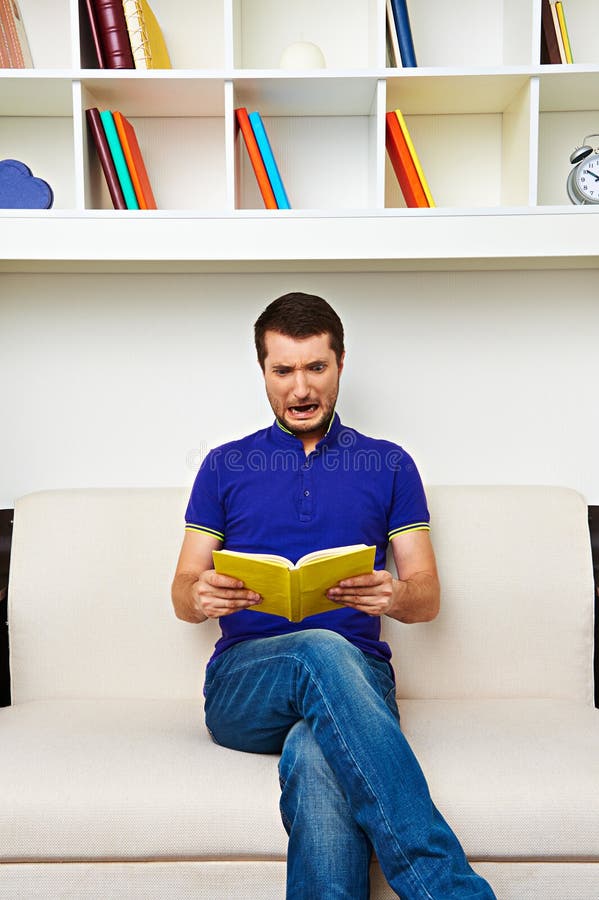 Scared man sitting on sofa stock image. Image of resting - 31251659