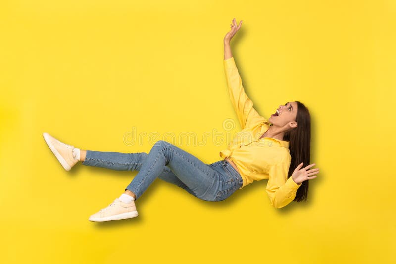 Scared Millennial Lady Falling in Mid-Air Shouting Over Yellow ...