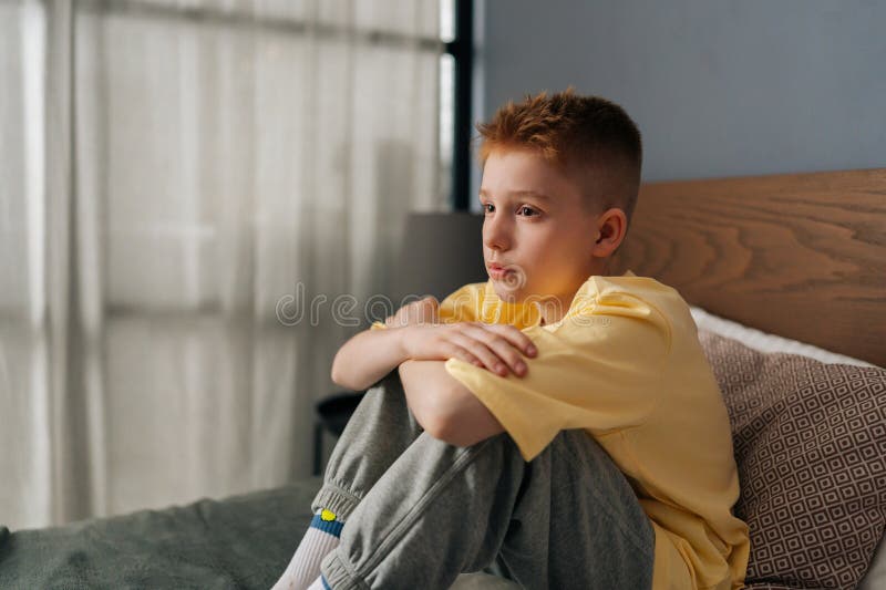 Scared Sad Little Boy Sitting on Bed Alone with Hugging Knee and ...