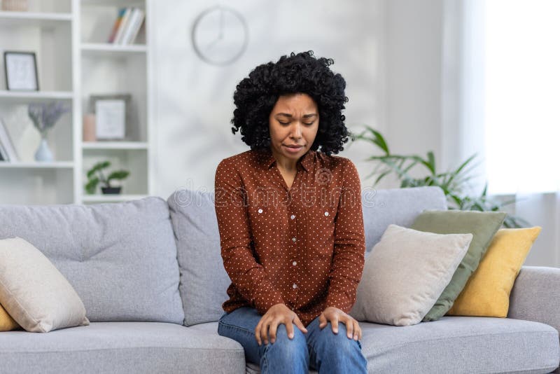 Scared and Upset Young Woman Sitting Sad on Sofa at Home, Suffering ...