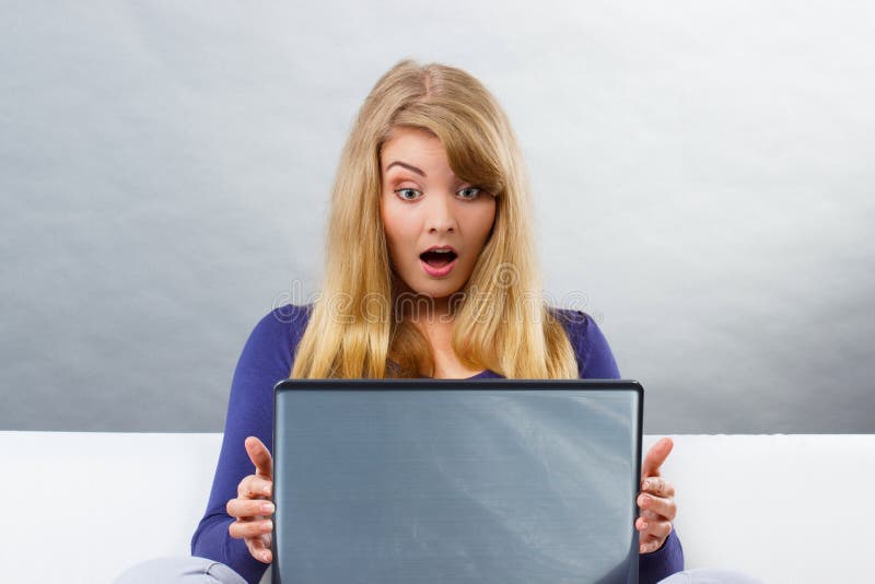 Scared Woman Sitting on Sofa and Looking at Her Laptop, Problem with ...
