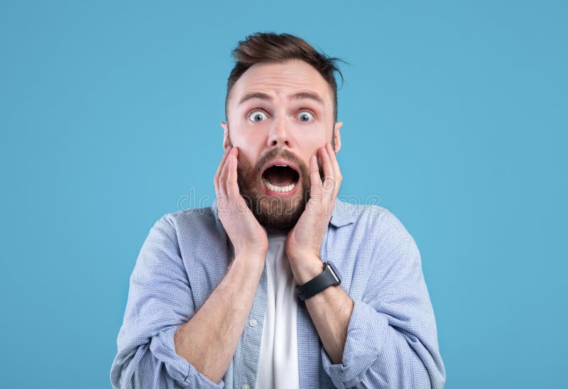 Scared Young Guy Screaming in Panic Over Blue Studio Background Stock ...