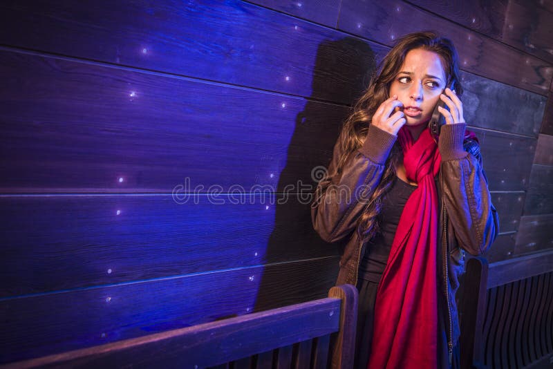 Scared Young Woman in Dark Walkway Using Cell Phone Stock Photo - Image ...