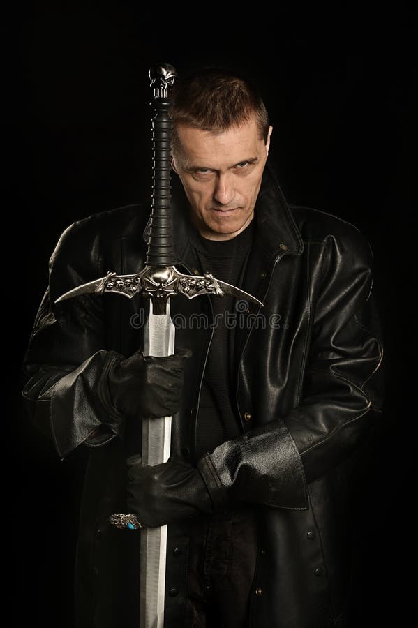 Man standing with a sword stock image. Image of adult - 62568997