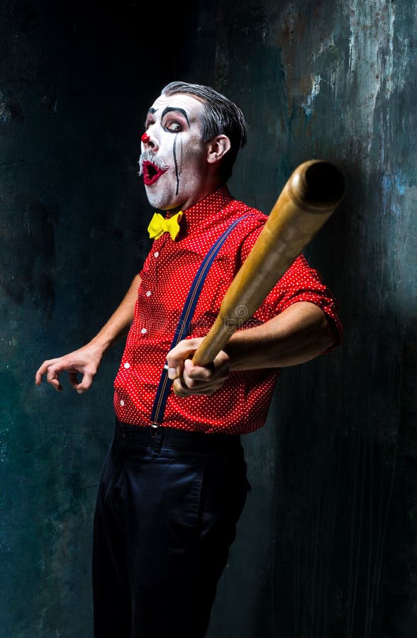 The Scary Clown and Baseball-bat on Dack Background. Halloween Concept ...