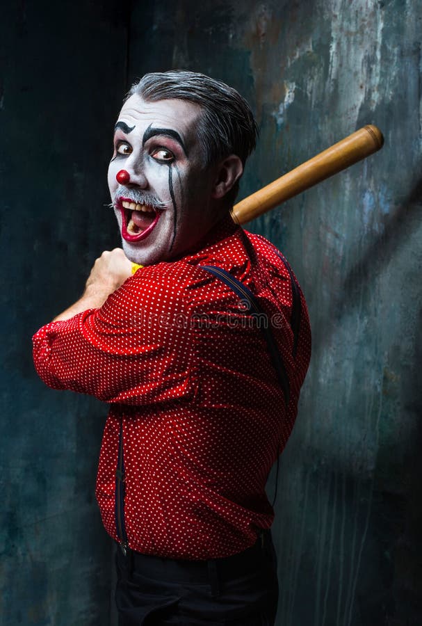 The Scary Clown and Baseball-bat on Dack Background. Halloween Concept ...