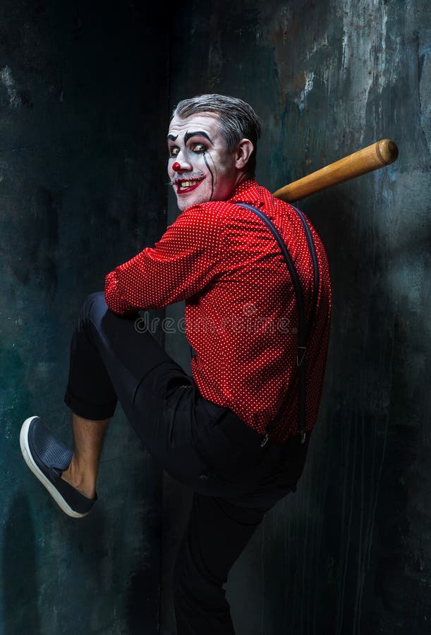 The Scary Clown and Baseball-bat on Dack Background. Halloween Concept ...