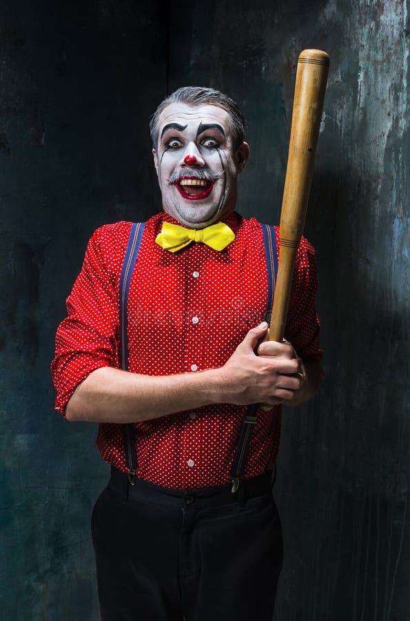 The Scary Clown and Baseball-bat on Dack Background. Halloween Concept ...