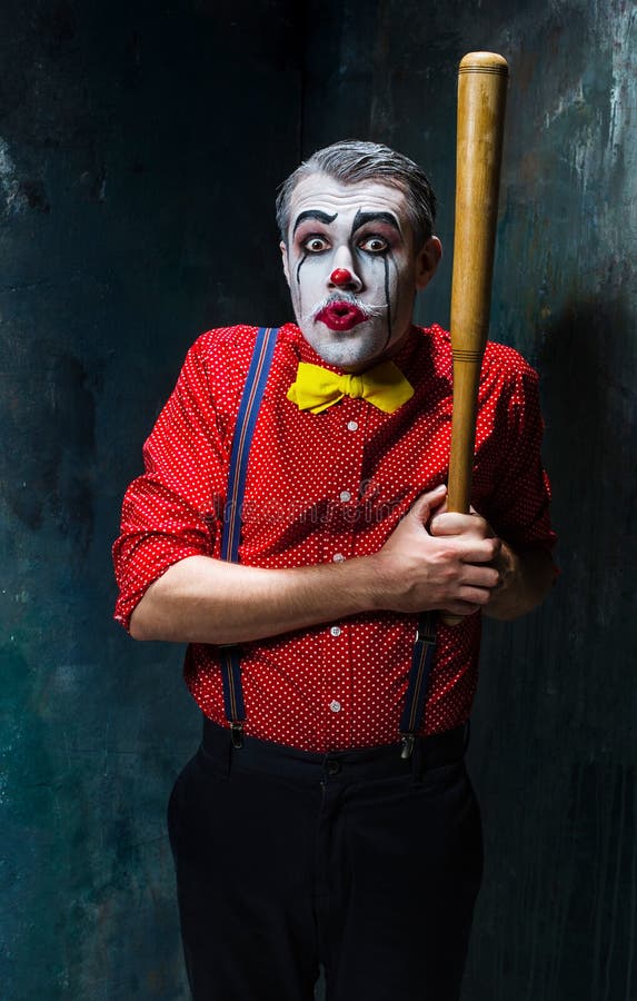 The Scary Clown and Baseball-bat on Dack Background. Halloween Concept ...